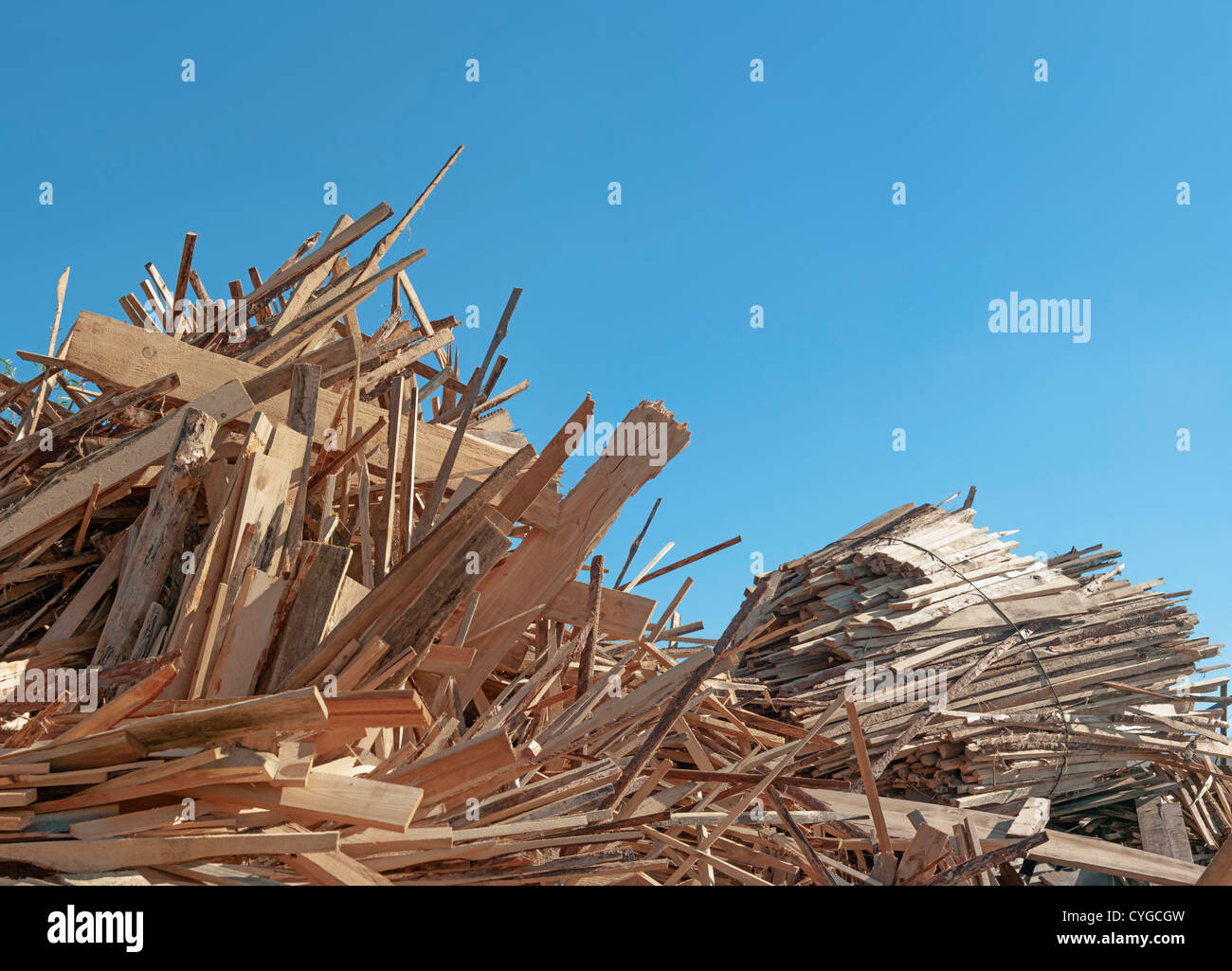 Firewood waste heap against the blue sky Stock Photo - Alamy