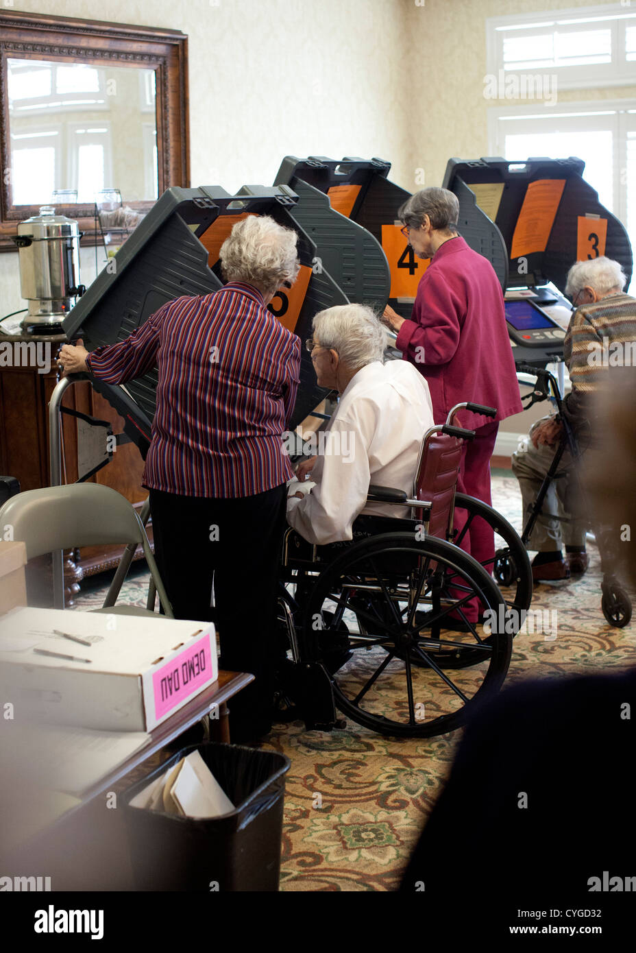 Senior citizens participate in early voting at an assisted living ...