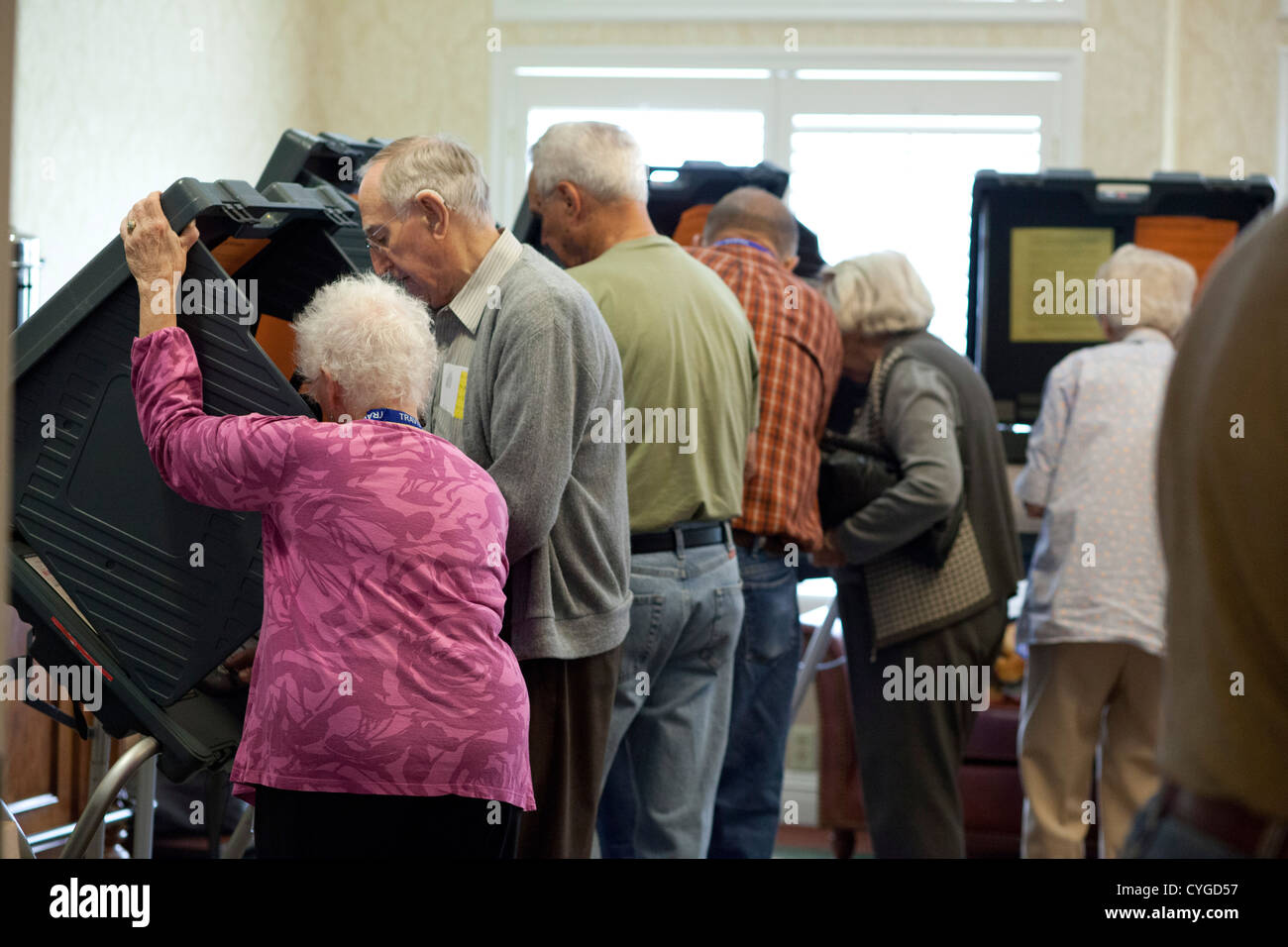 Senior citizens participate in early voting at an assisted living ...