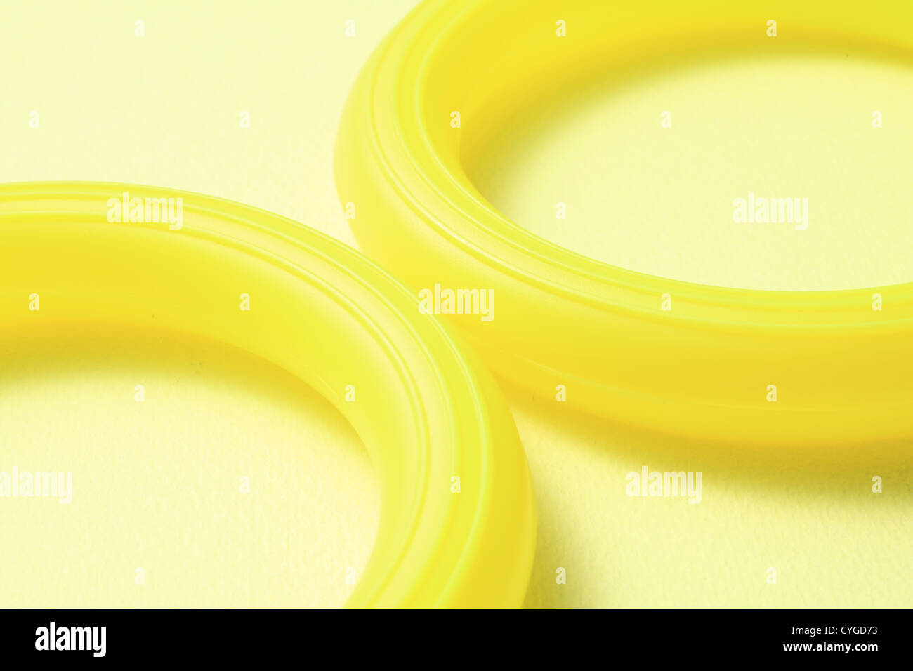 Two yellow rings on yellow background Stock Photo - Alamy