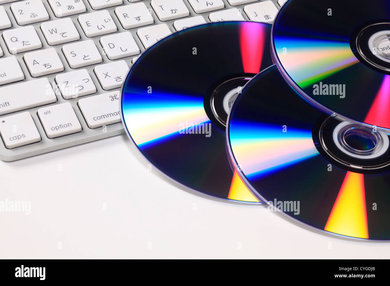 DVD disks on a keyboard Stock Photo - Alamy