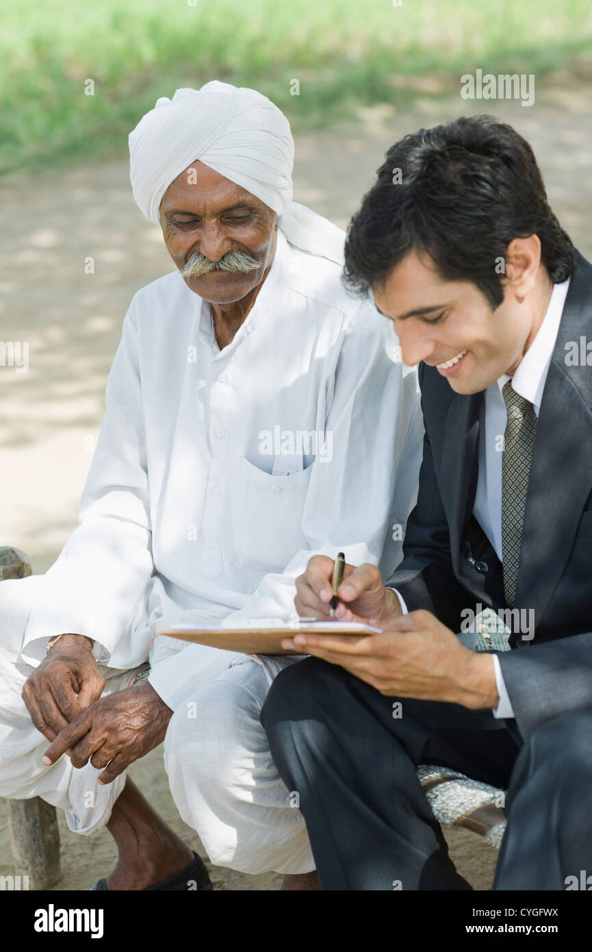 Financial advisor explaining to a farmer about agriculture loan Stock ...
