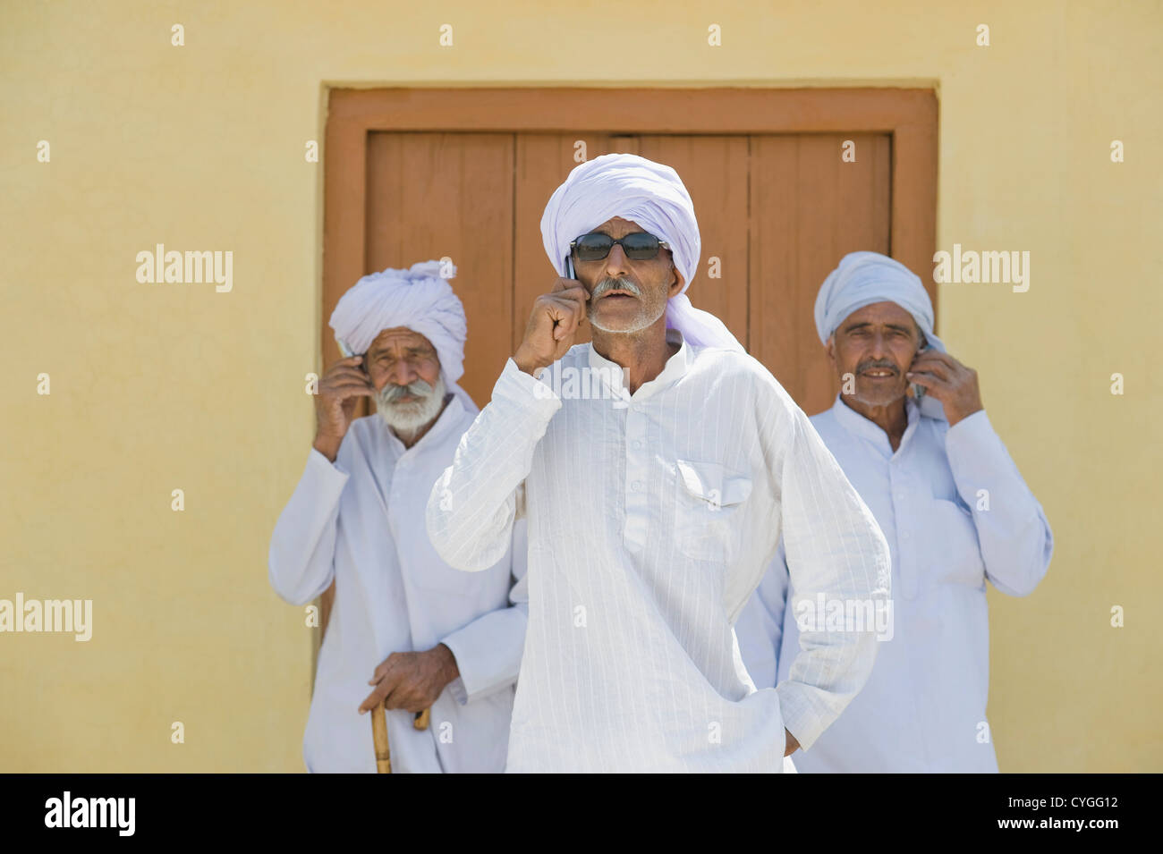 Three farmers talking on mobile phones Stock Photo - Alamy