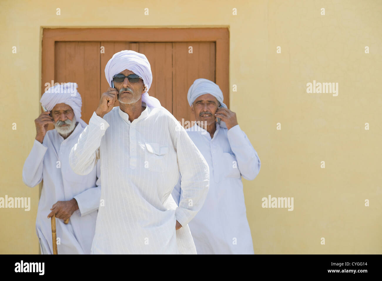 Three farmers talking on mobile phones Stock Photo - Alamy