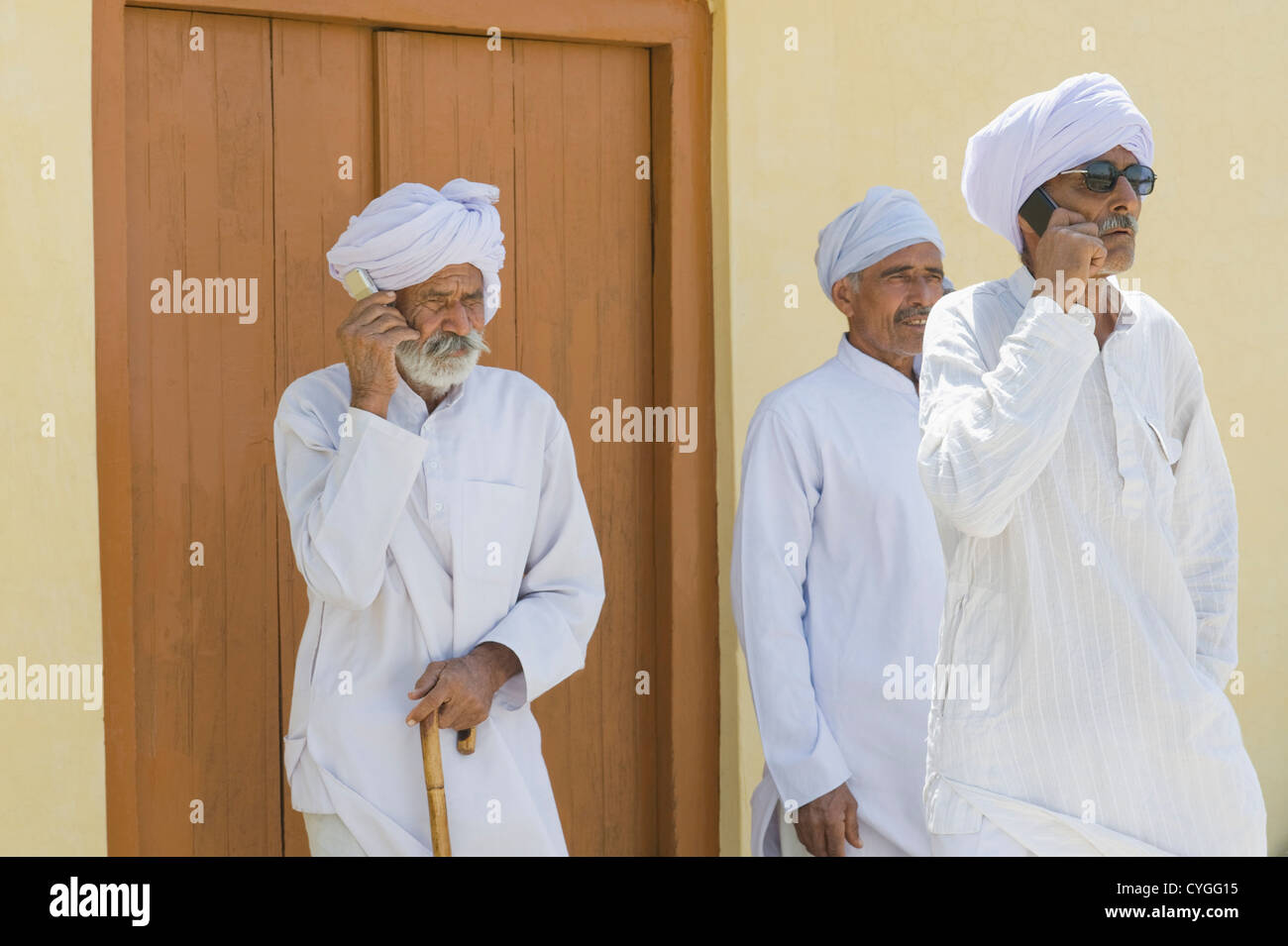Three farmers talking on mobile phones Stock Photo - Alamy