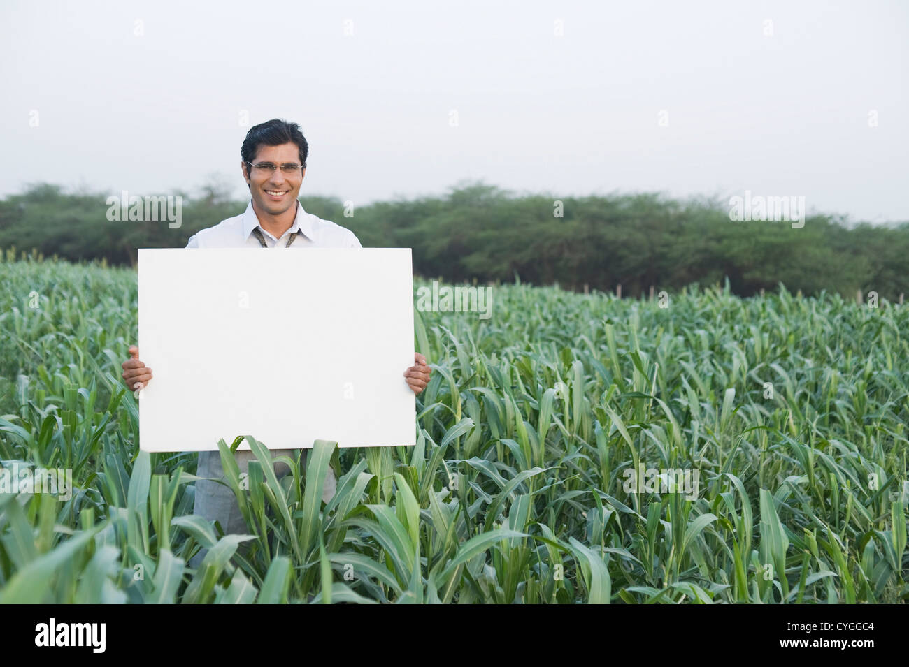 Indian man showing placard smiling hi-res stock photography and images ...