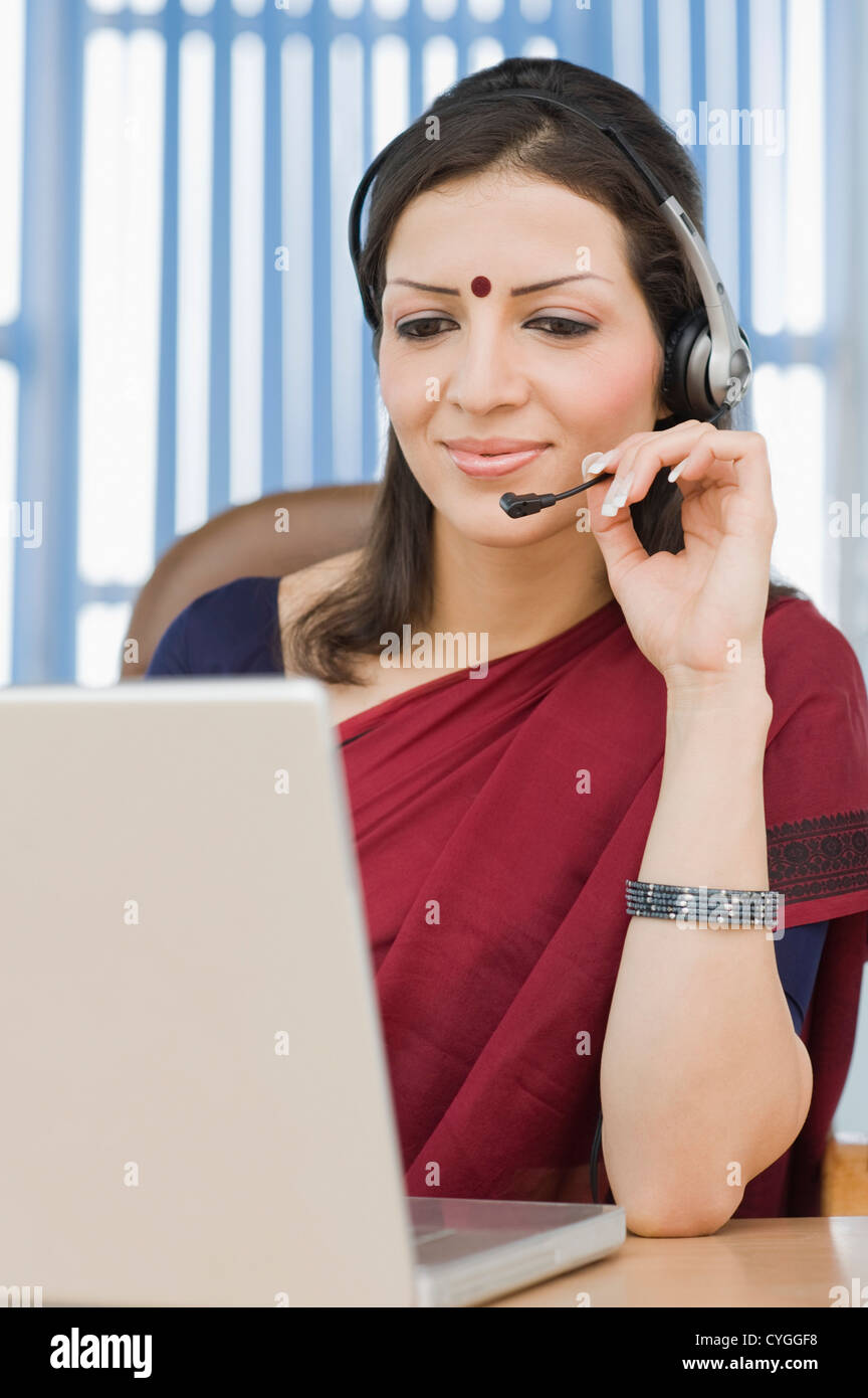 Female customer service representative using a laptop Stock Photo - Alamy