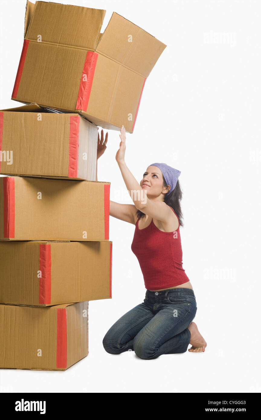 Woman balancing cardboard boxes Stock Photo - Alamy