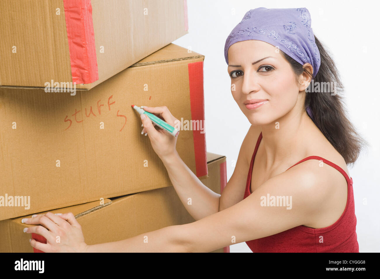 Woman writing on a cardboard box Stock Photo - Alamy