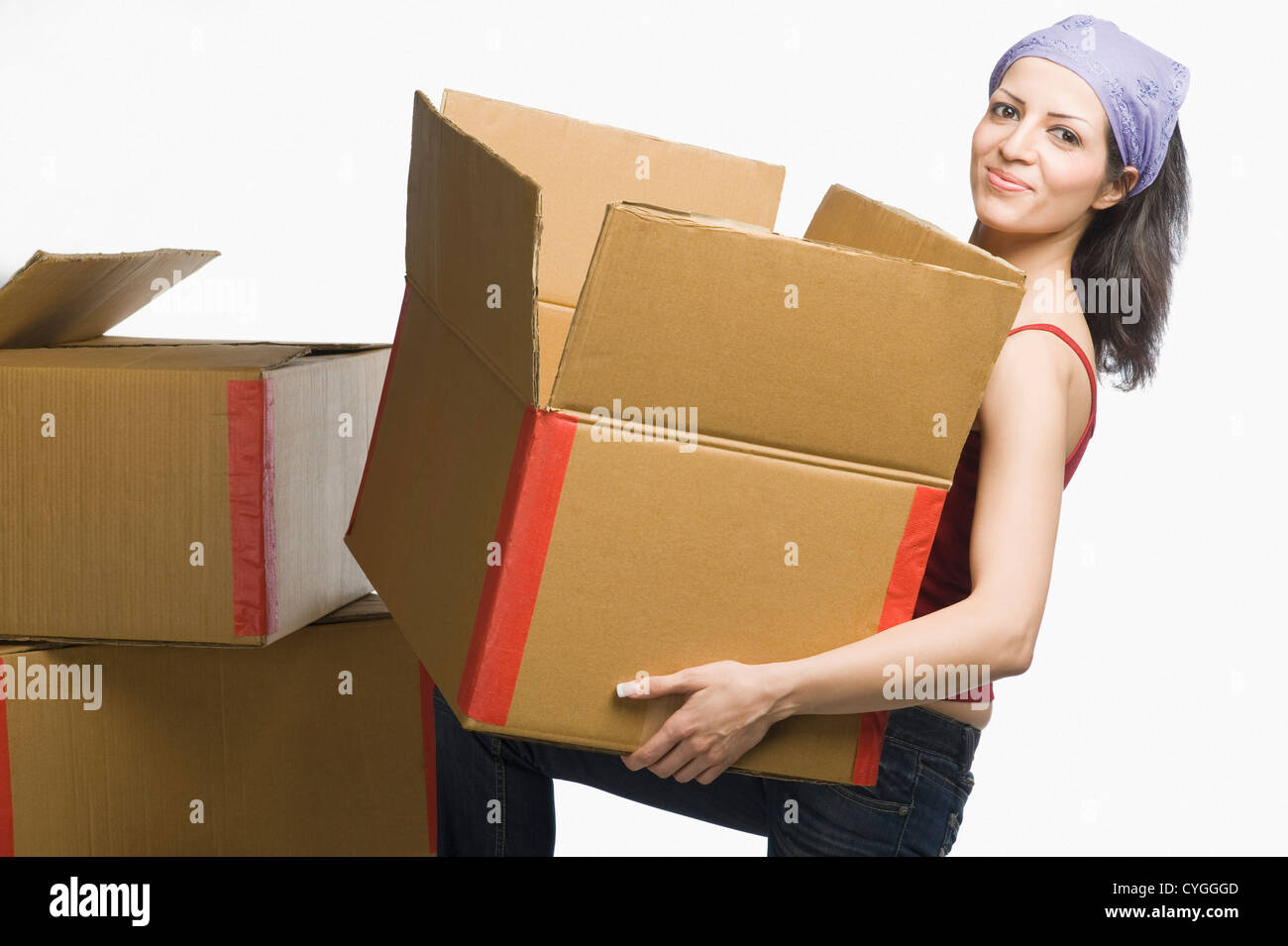 Portrait of a woman carrying a cardboard box Stock Photo - Alamy