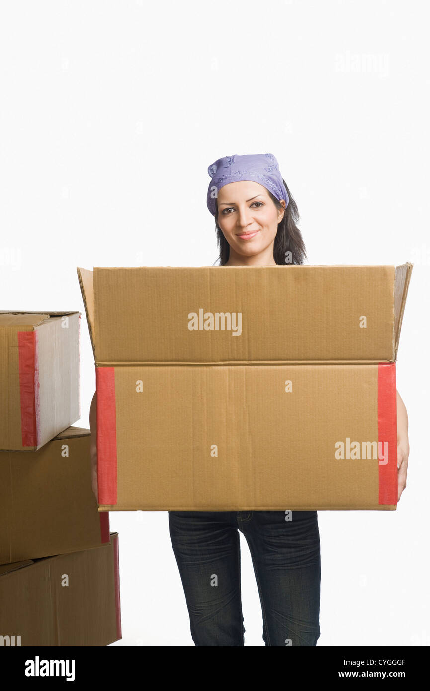 Portrait of a woman carrying a cardboard box Stock Photo - Alamy