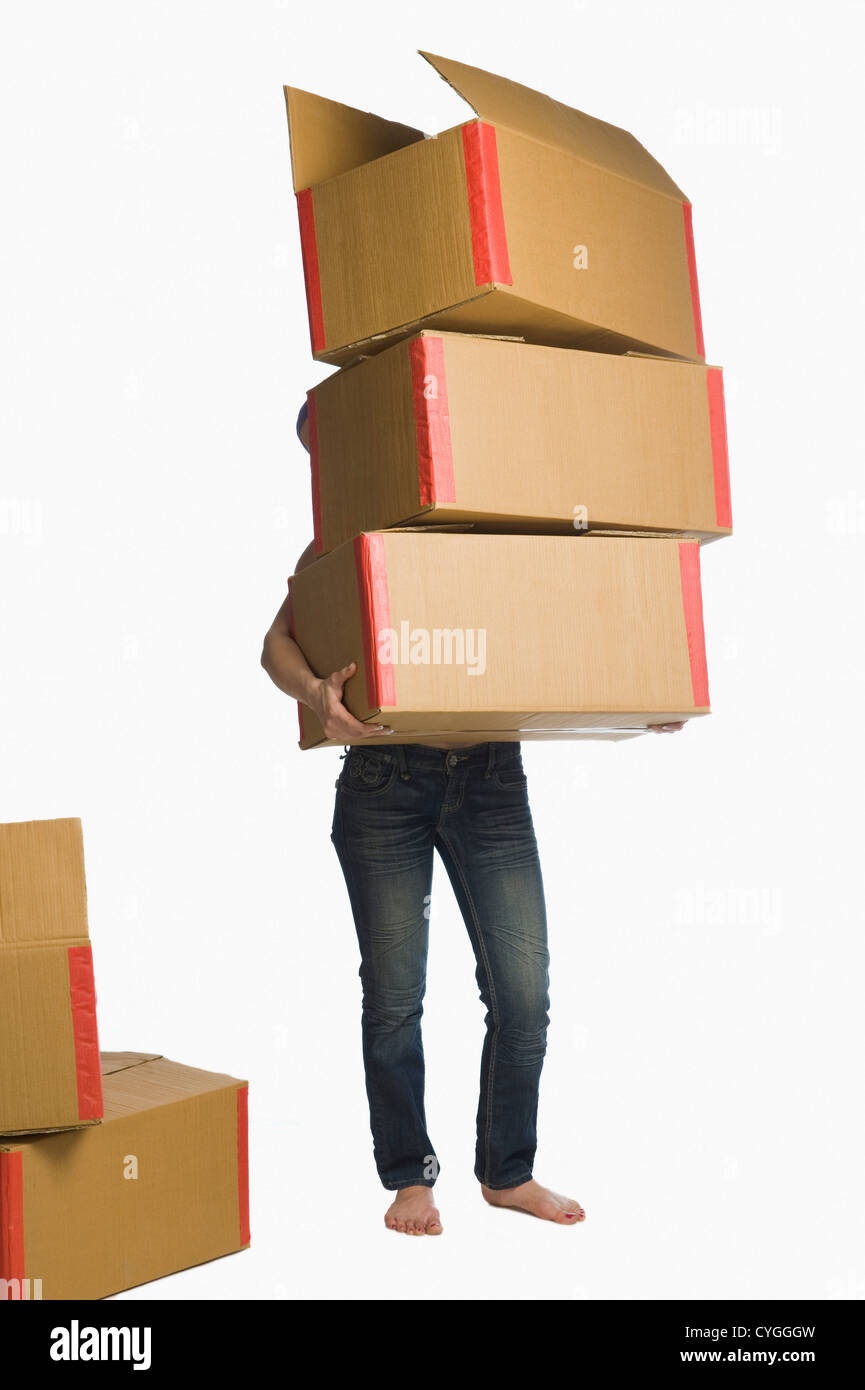Young woman carrying stack cardboard hi-res stock photography and ...