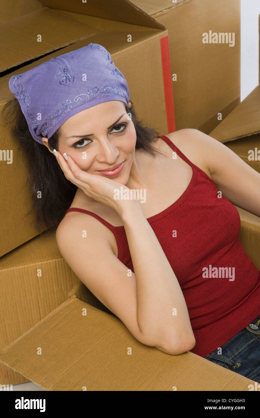 Portrait of a woman reclining on cardboard boxes and smiling Stock ...