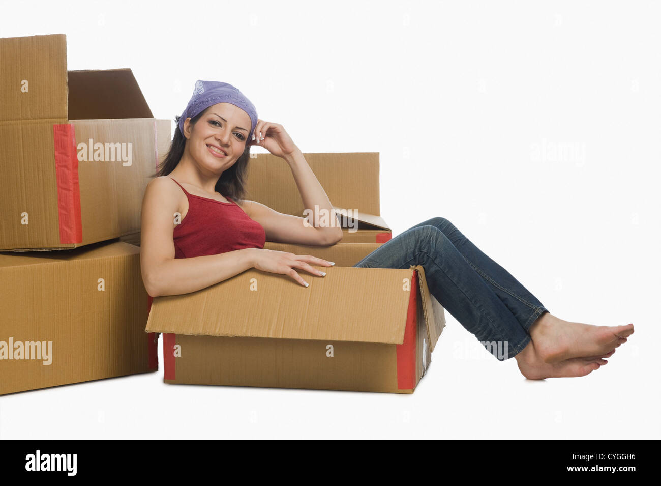 Portrait of a woman resting in a cardboard box Stock Photo - Alamy