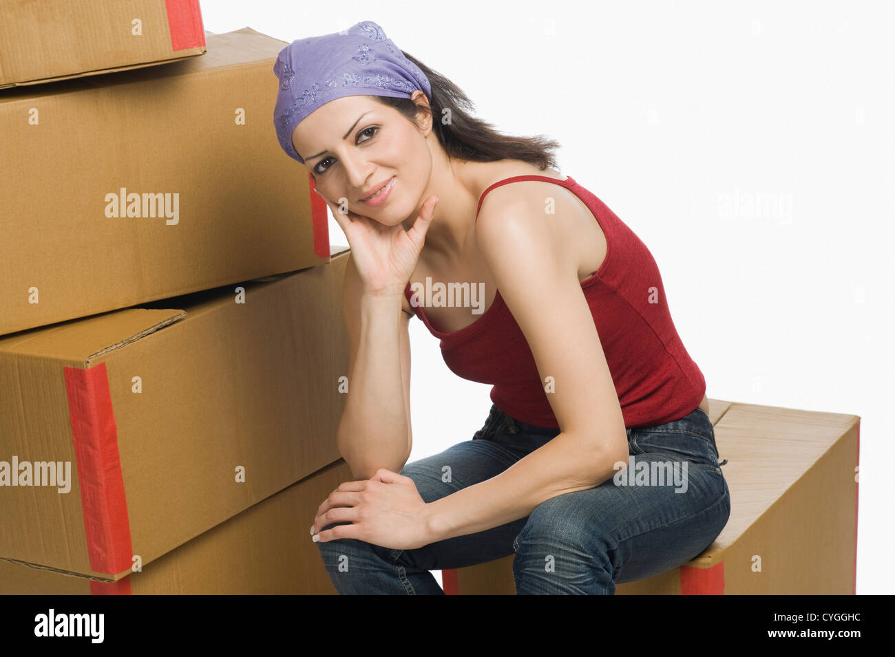 Portrait of a woman resting on a cardboard box Stock Photo - Alamy