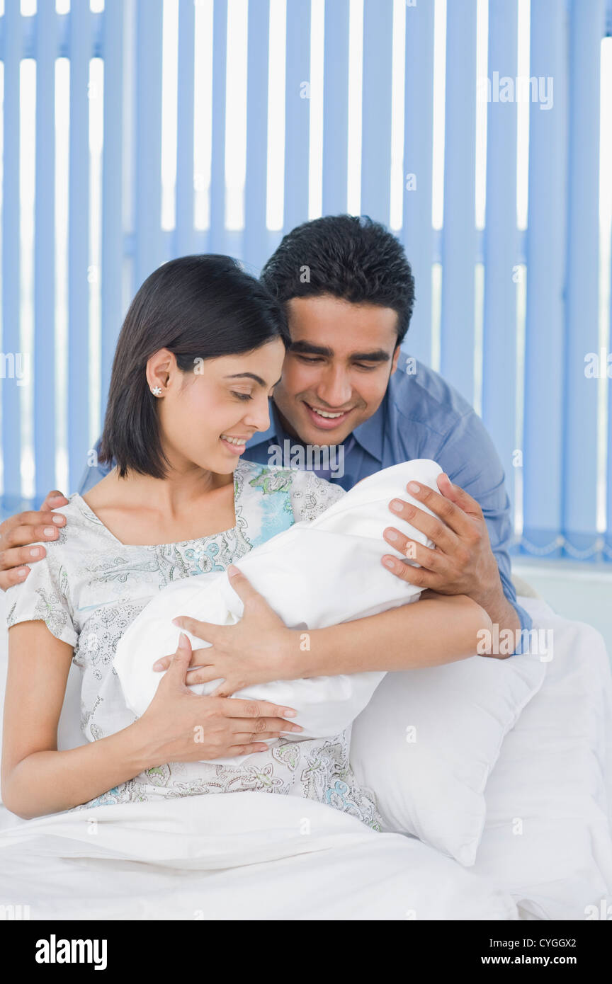 Parents with their newborn baby in a hospital Stock Photo - Alamy