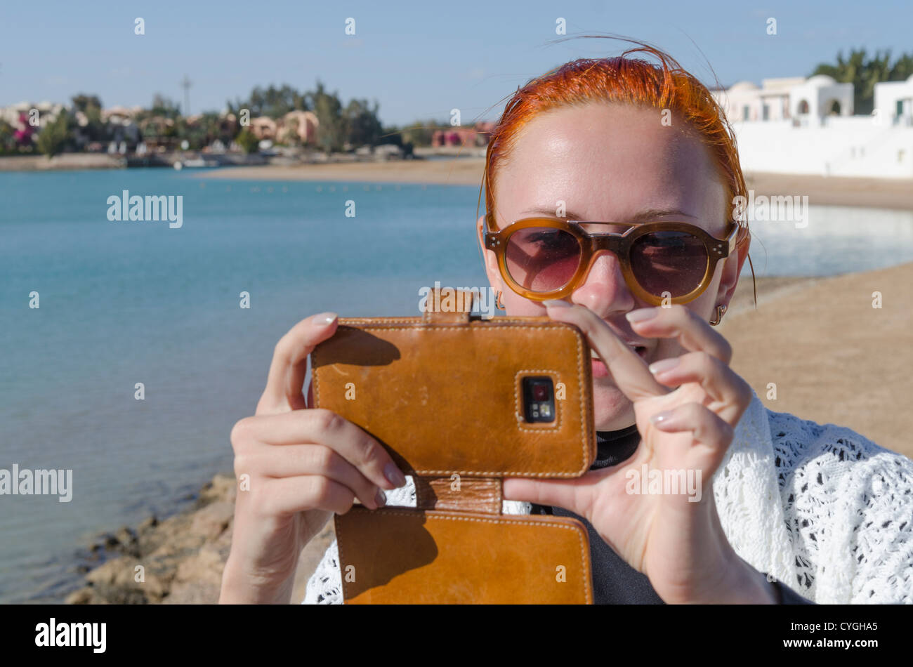 Young tourist woman taking photos with mobile phone Stock Photo - Alamy