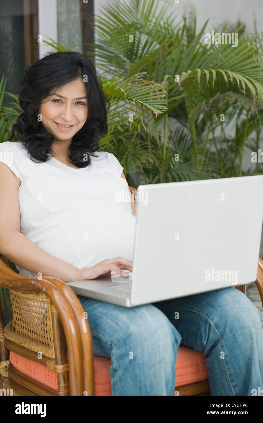 Portrait of a pregnant woman using a laptop Stock Photo - Alamy