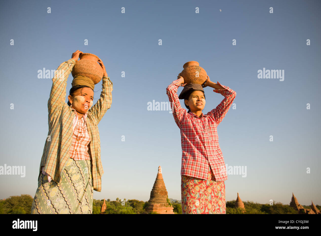 traditional farmers at myanmar, bagan carrying pots Stock Photo - Alamy