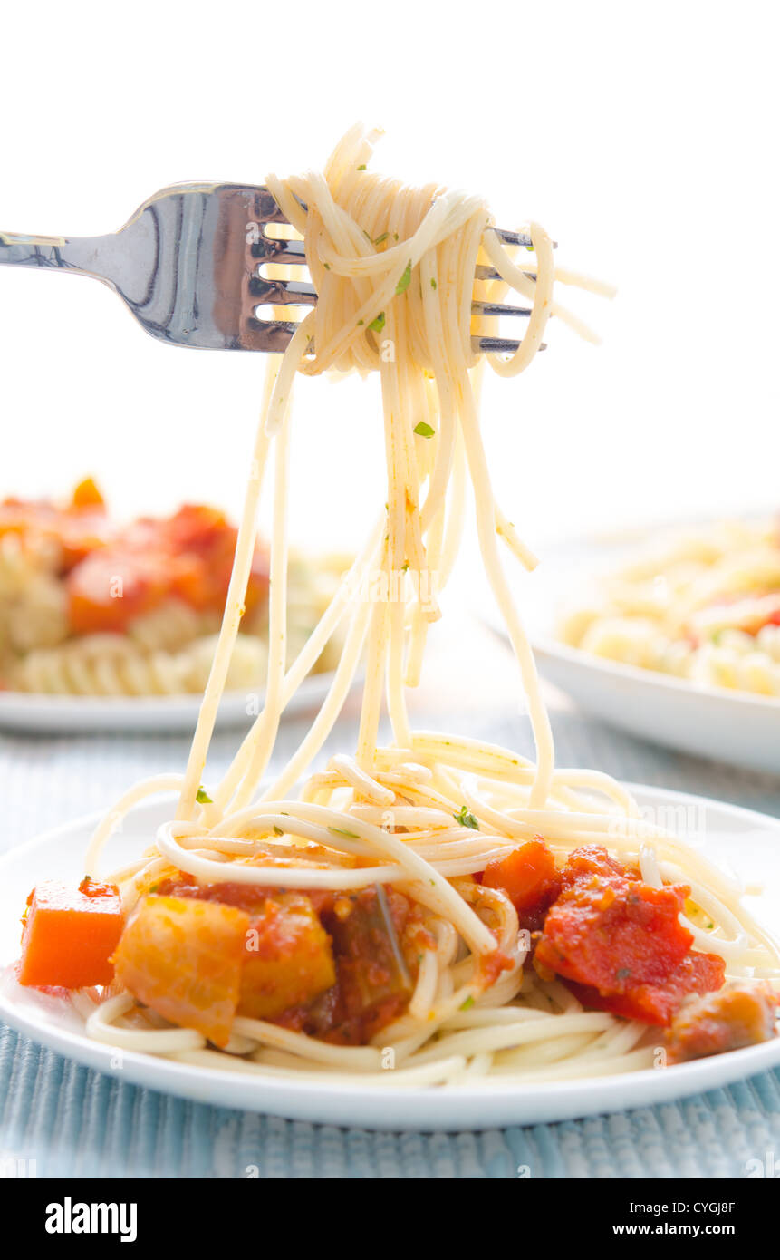 spaghetti hanging on a fork at dinner Stock Photo - Alamy