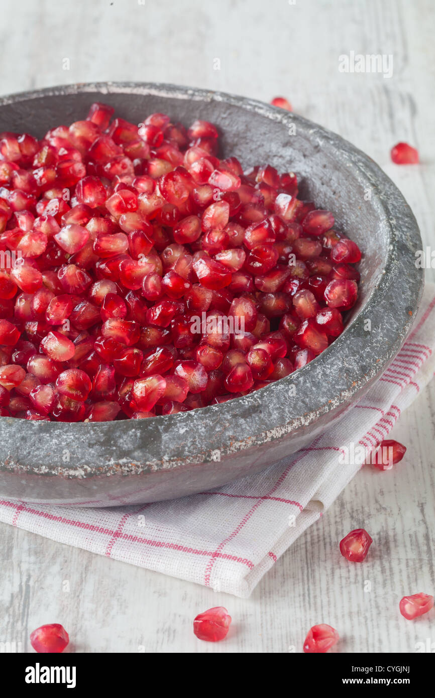 Grains of fresh pomegranate in a stone plate Stock Photo - Alamy