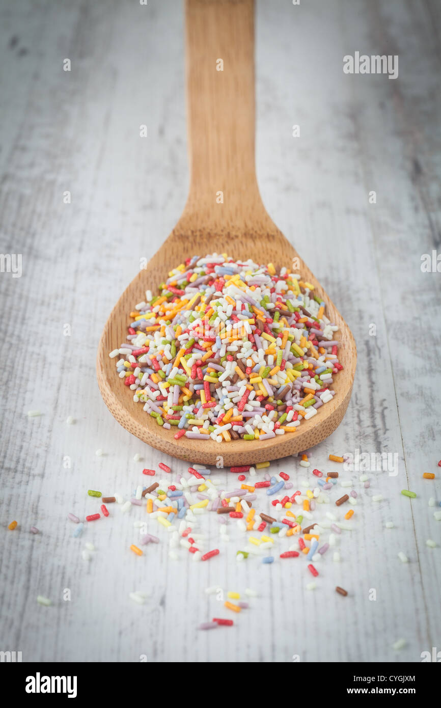 Colorful sugar sprinkles on a wooden spoon Stock Photo - Alamy