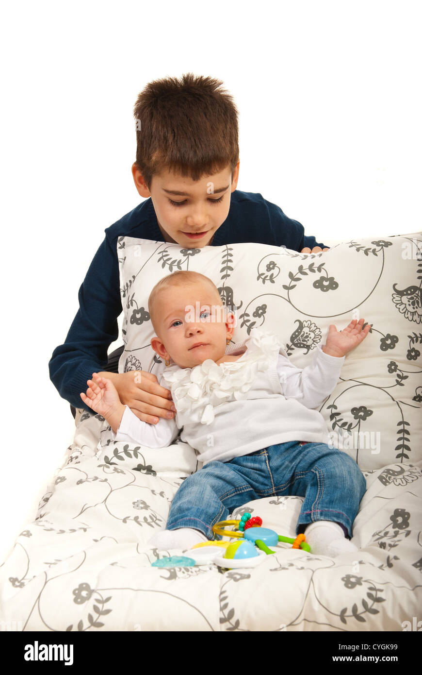 Boy caring his little baby sister against white background Stock Photo ...