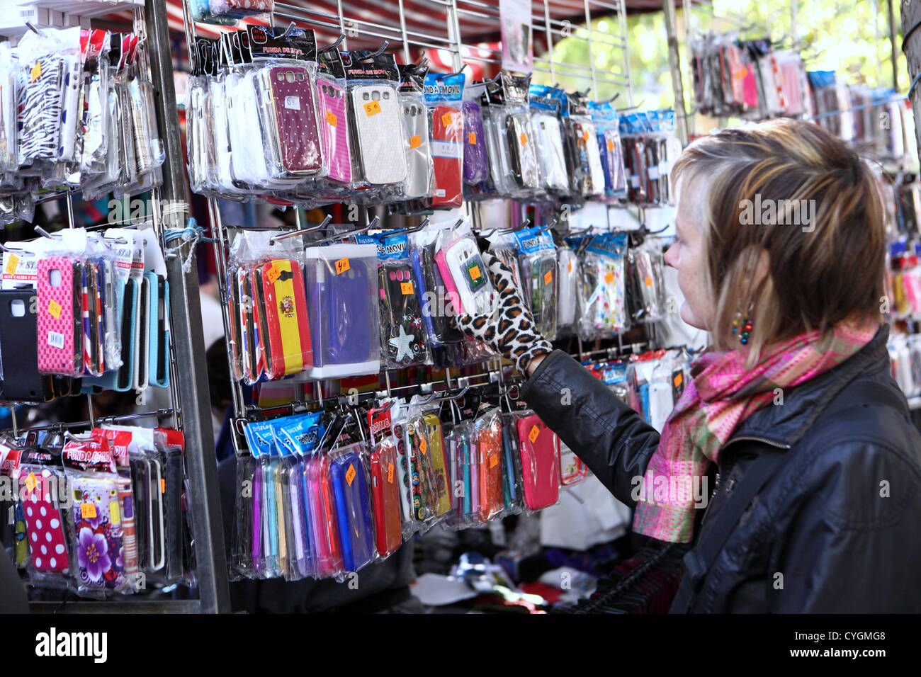 Woman shop female tourist chooses from wide selection of smart phone ...