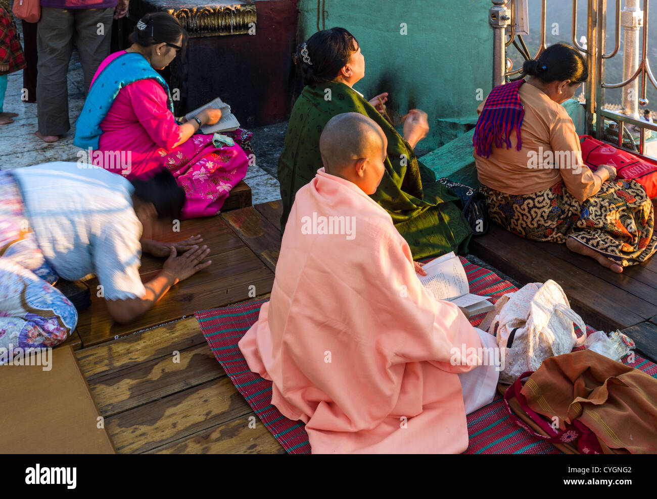 Myanmar, Kyaikhto, religious in prayer in front of the golden sacred ...