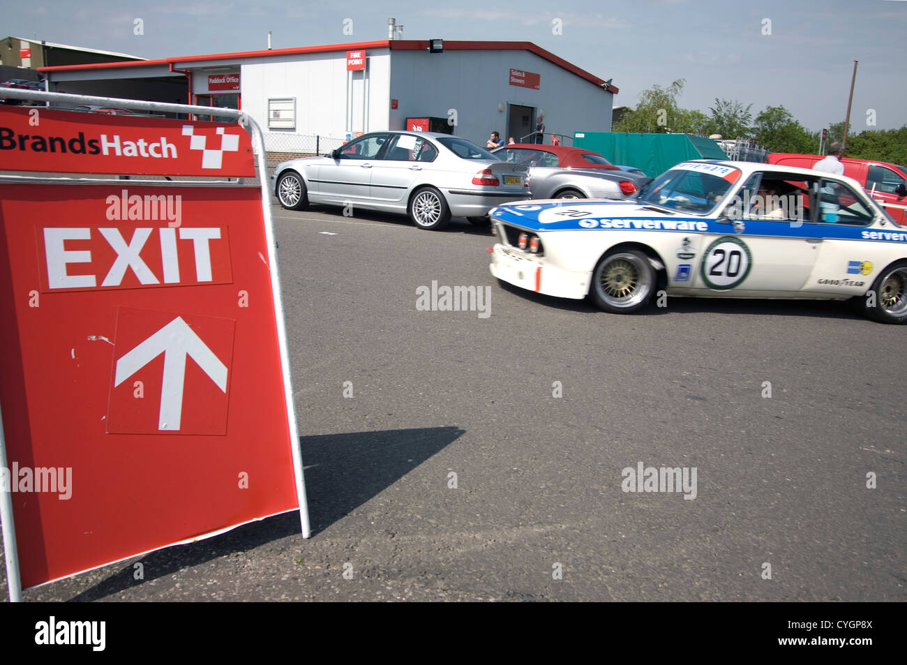 A racing car driving past an exit sign at a racing circuit Stock Photo ...