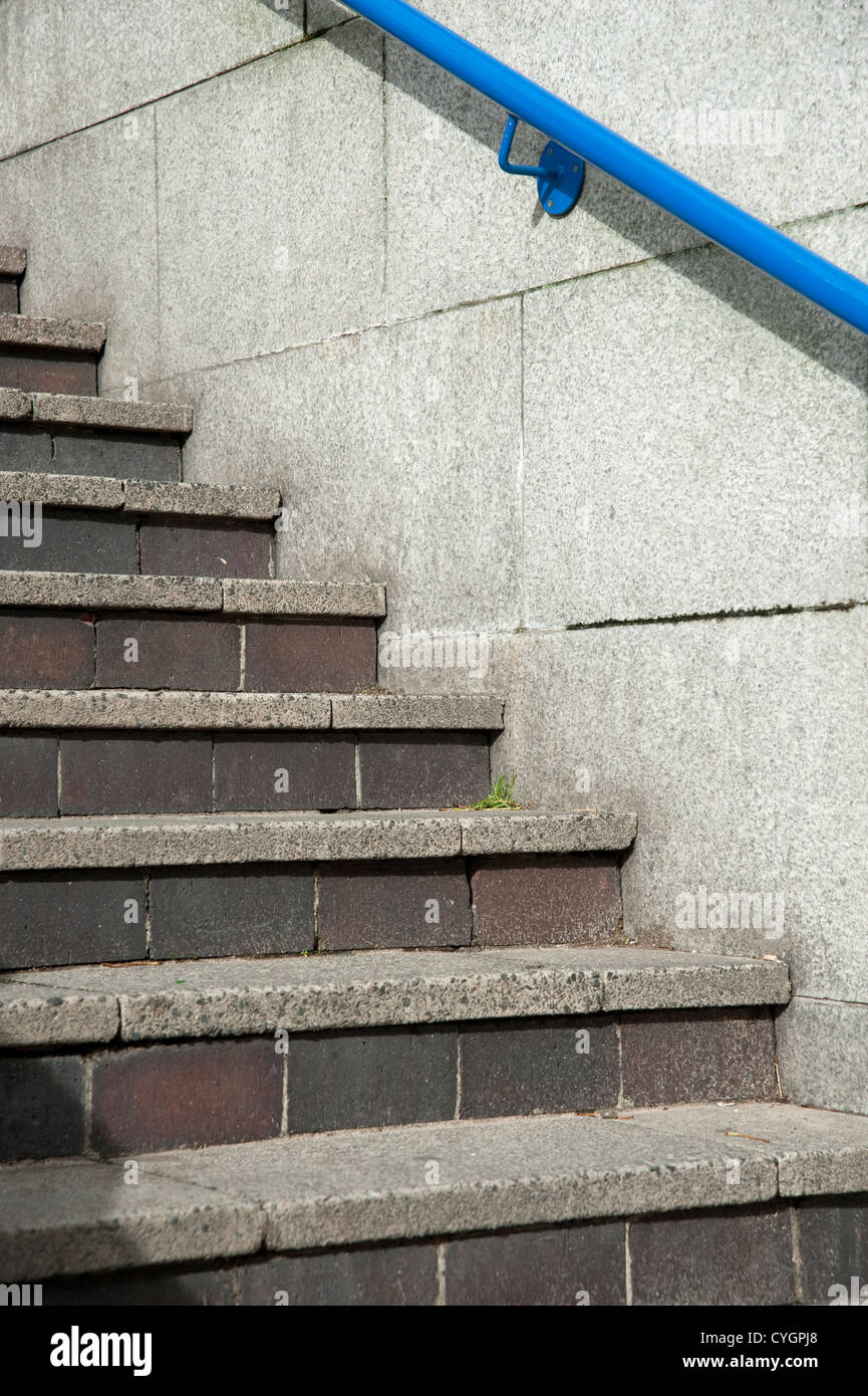 Steps leading upwards with blue handrail Stock Photo - Alamy