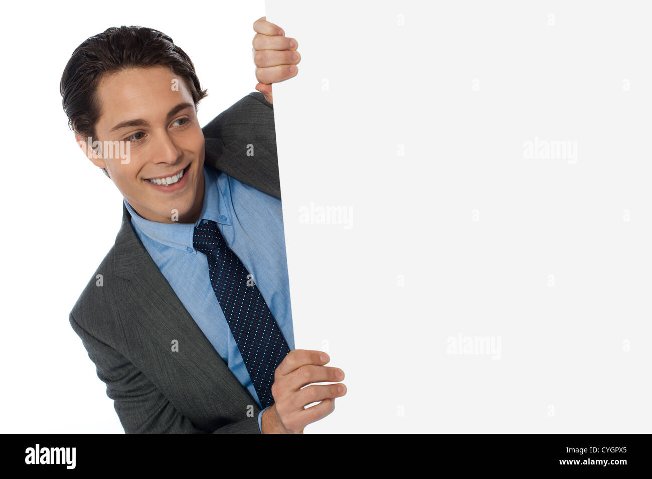 Businessman looking around the corner isolated on white background ...