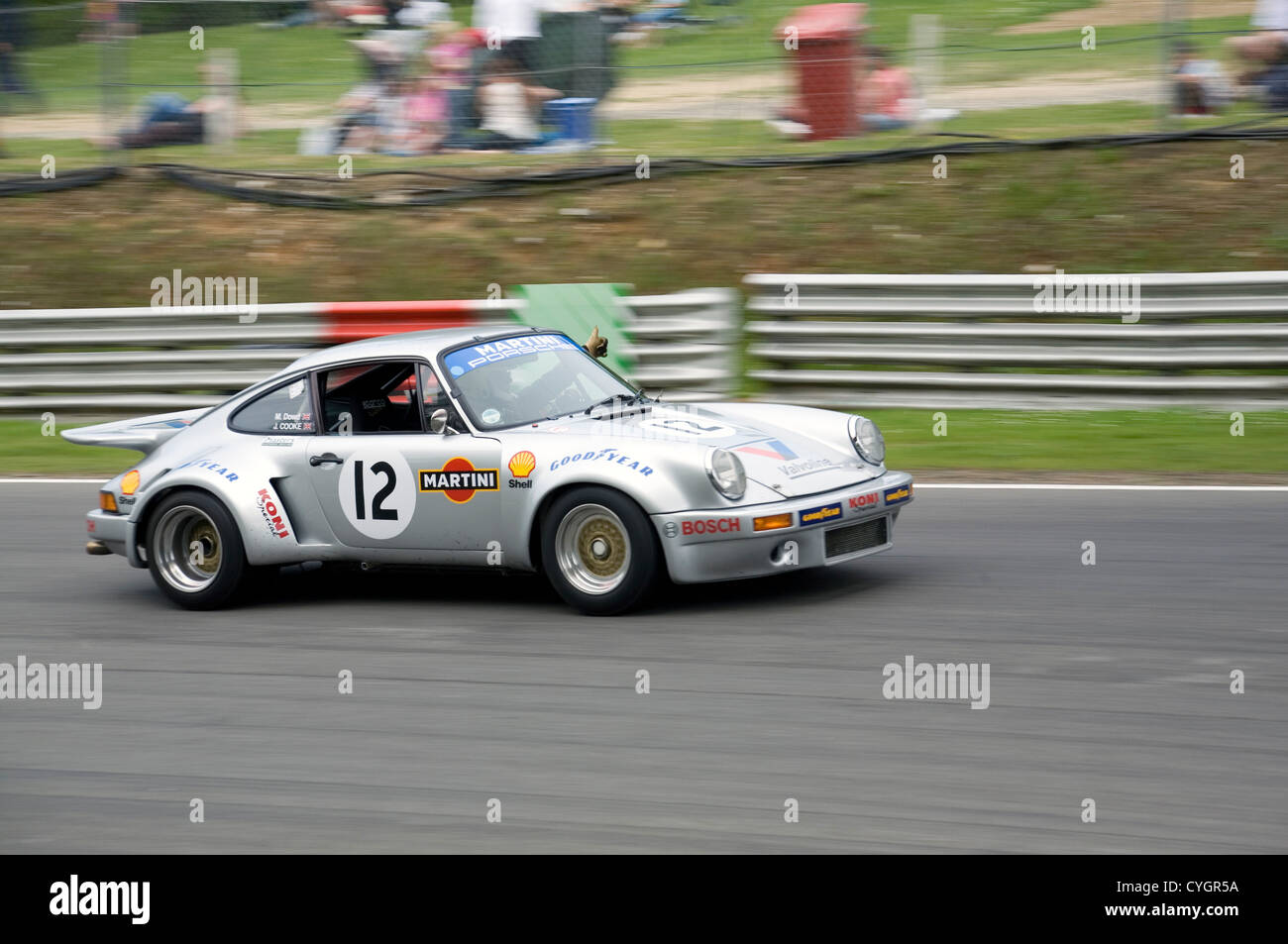 A historic Porsche 911 racing car traveling fast on a racing circuit ...
