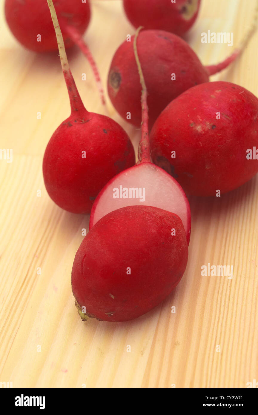fresh red raw raddish over pine wood table closeup Stock Photo - Alamy