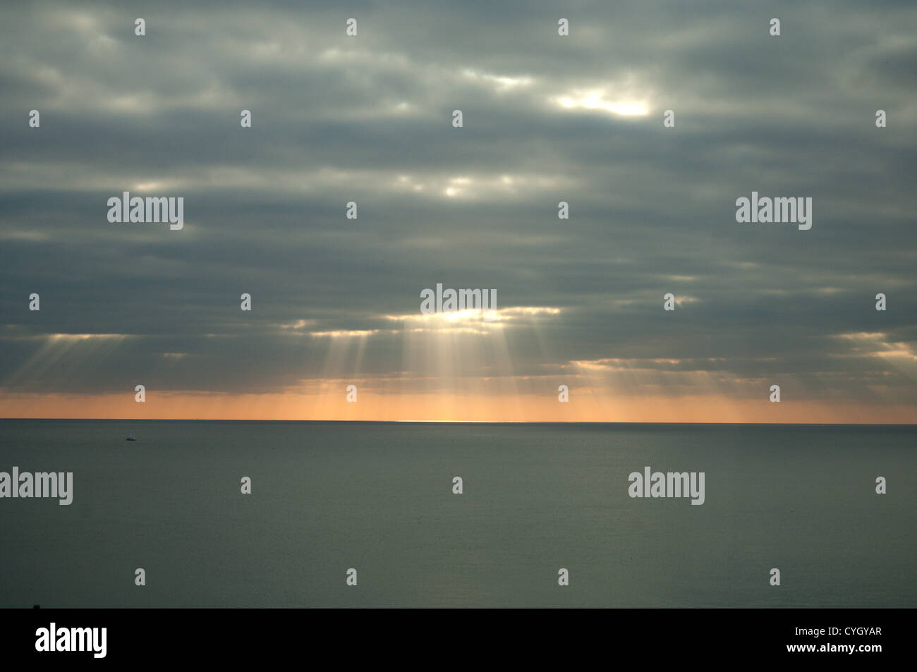 Sunset Through Clouds Stock Photo - Alamy