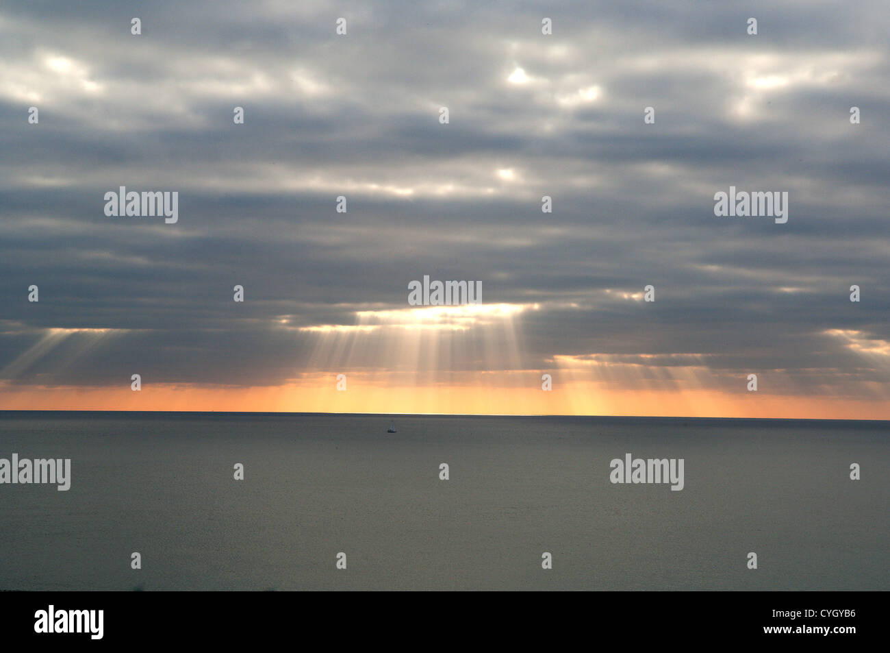 Sunset Through Clouds Stock Photo - Alamy