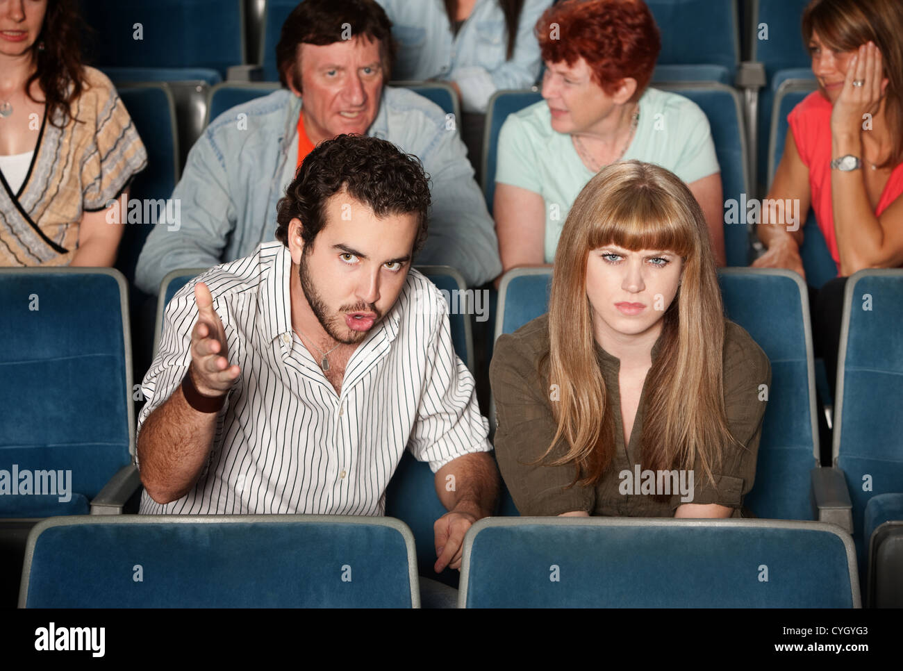 Serious movie fans angry in a theater Stock Photo - Alamy