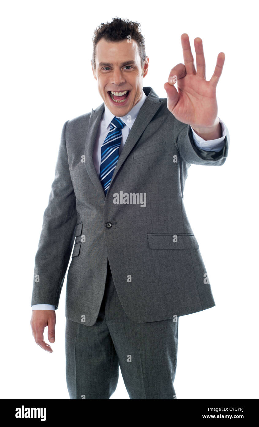 Handsome corporate man gesturing excellent againgt white background ...