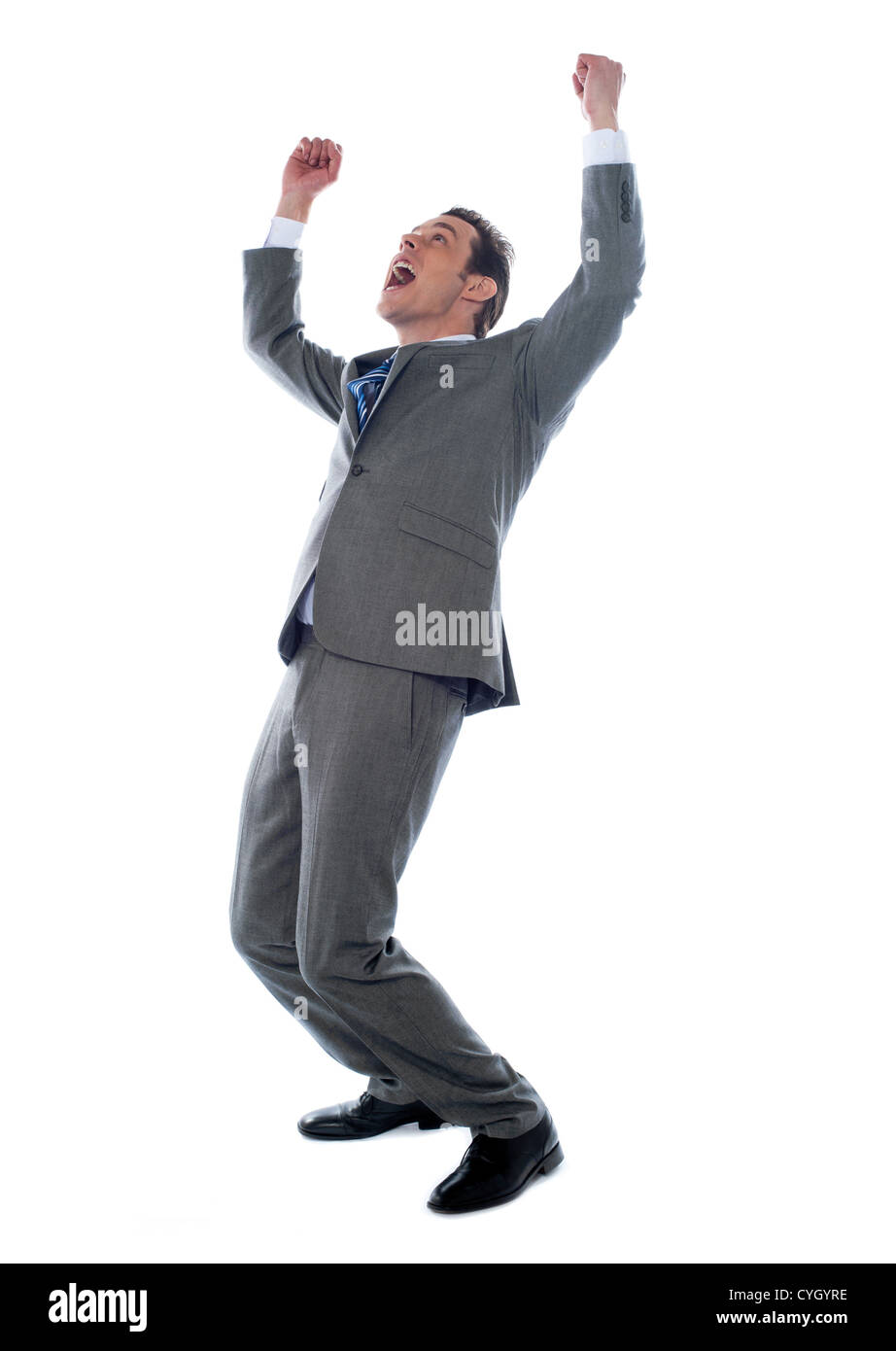 Successful businessman celebrating with arms up isolated over a white ...