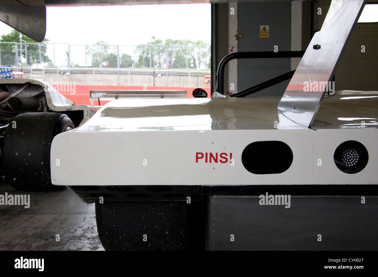 A Pins caption printed on the back of a racing car Stock Photo - Alamy