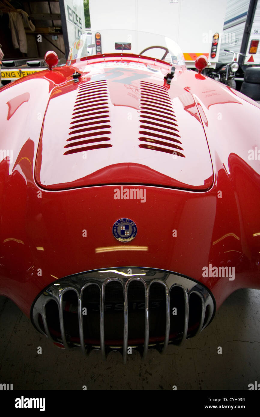 The nose of a red classic racing car with a distinctive circular front ...