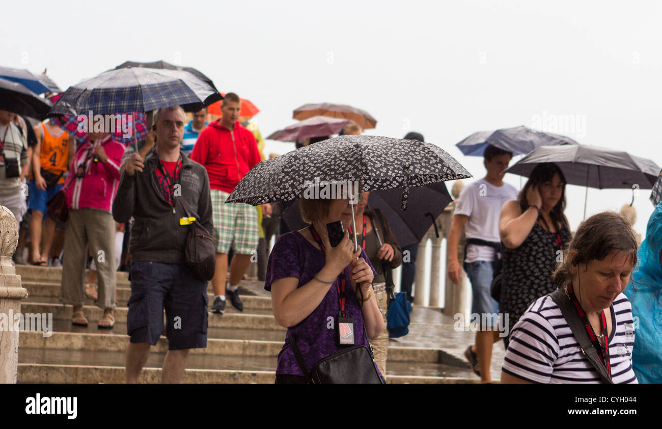 crowds of Tourists in the heavy rain. Venice waterfront.Italy Stock ...