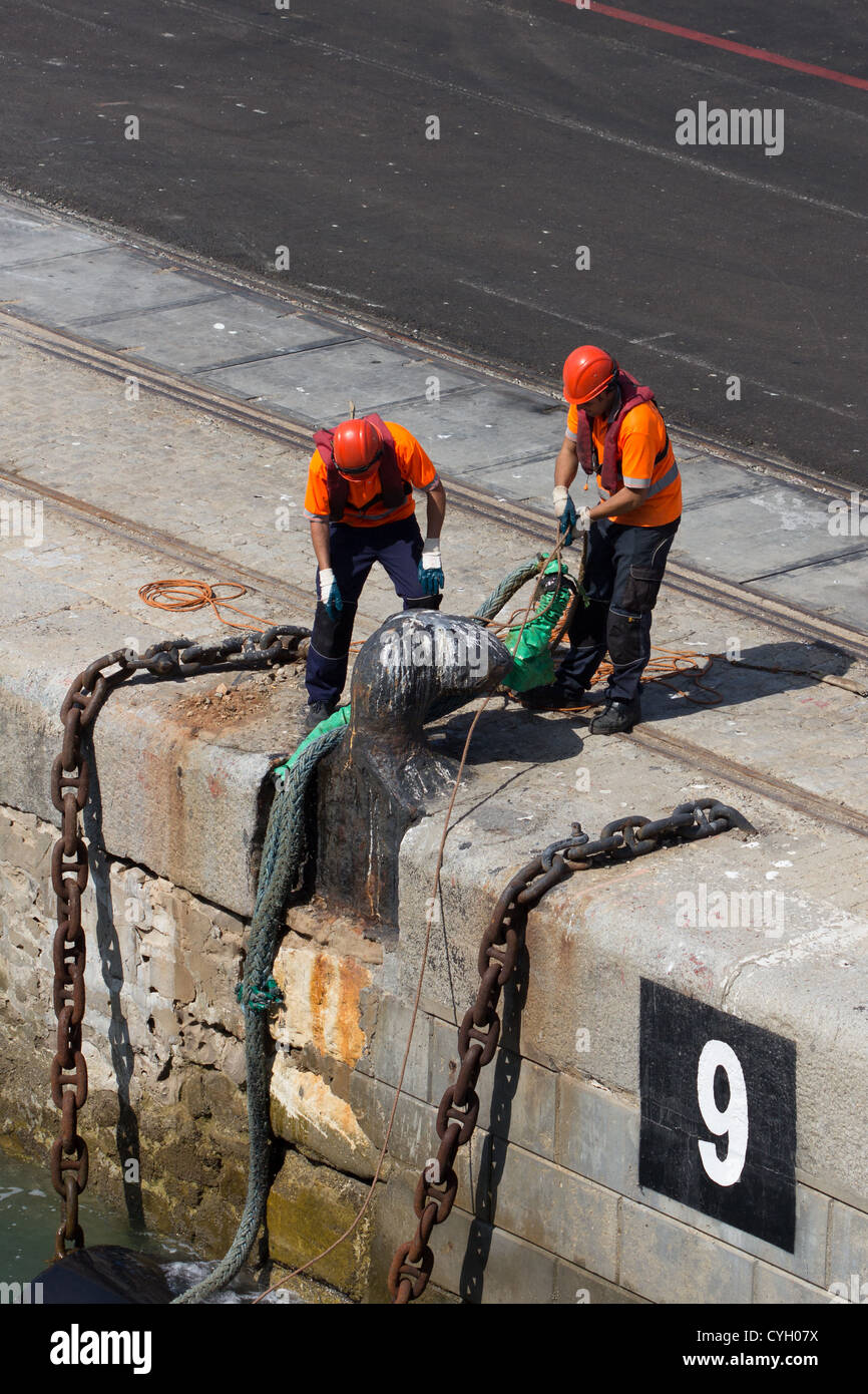 Shoremen securing lines of Passenger ship Cadiz Spain Stock Photo - Alamy