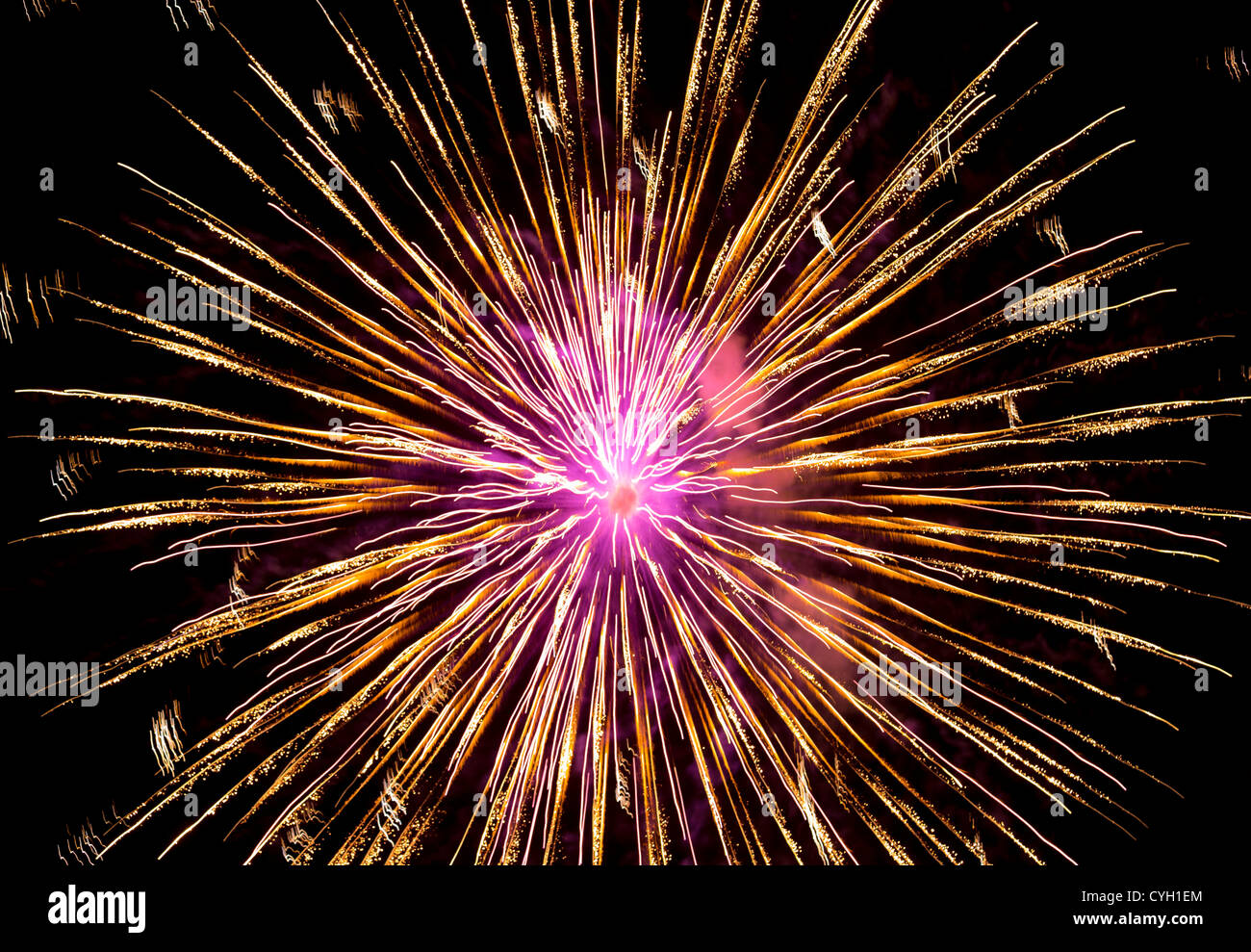 Firework exploding in a starburst of pink and orange light Stock Photo ...