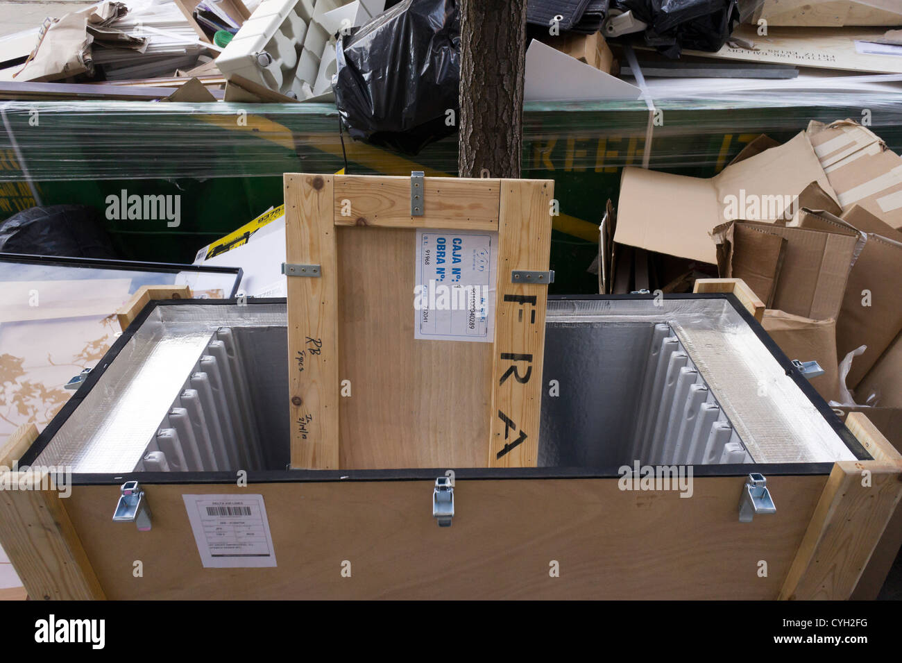 Debris, including a damaged art packing crate, in a dumpster in the ...