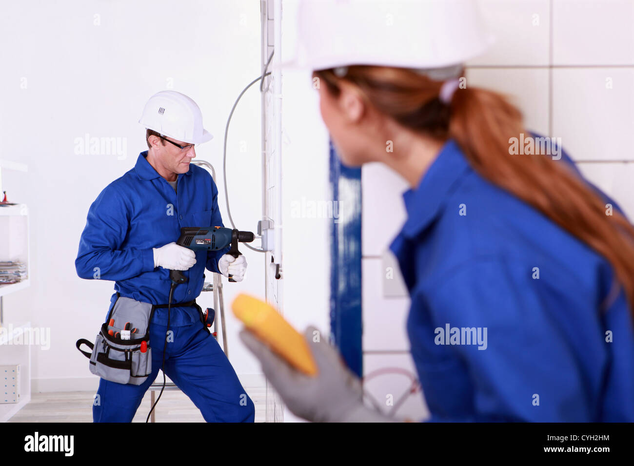 Workers renovating a kitchen Stock Photo - Alamy