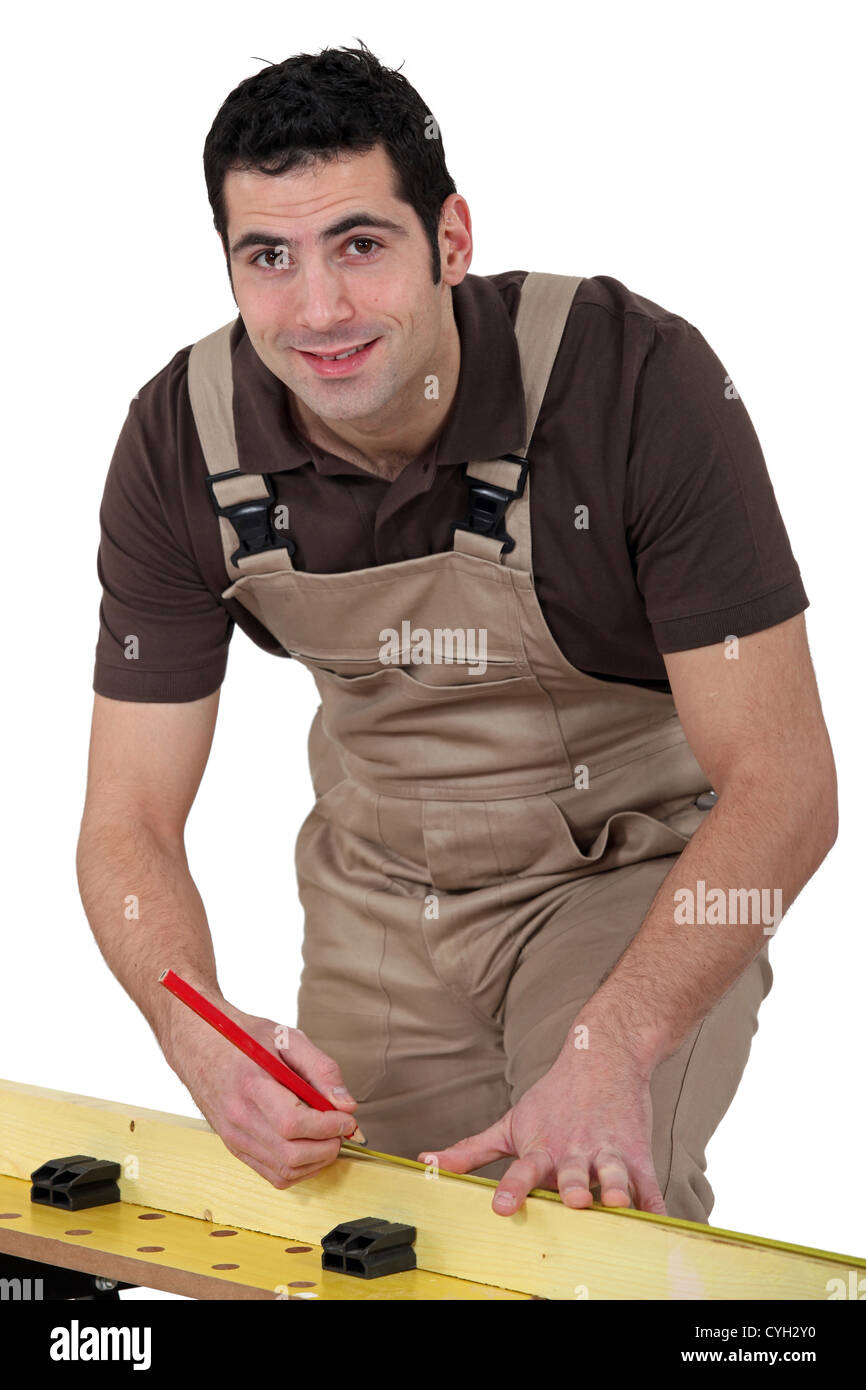 Man marking a piece of wood Stock Photo - Alamy