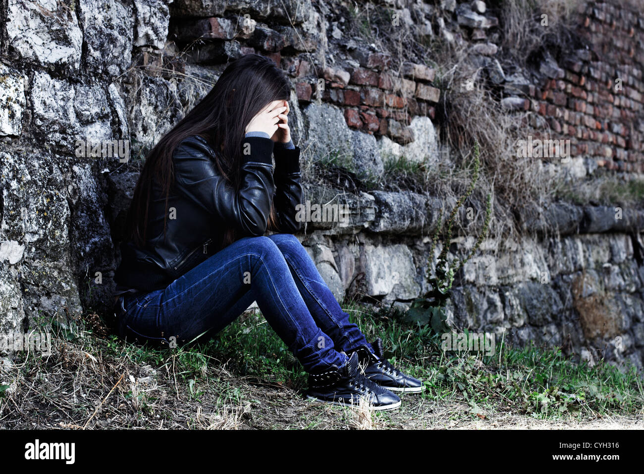 Depressed teenage girl with hands over her face Stock Photo - Alamy