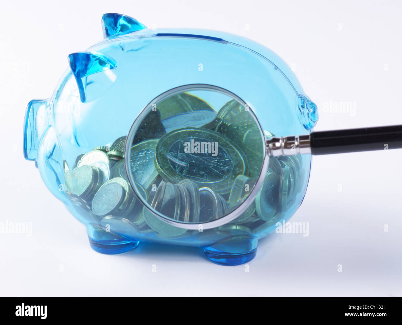 Magnified coins in a piggy bank. Studio shot Stock Photo - Alamy