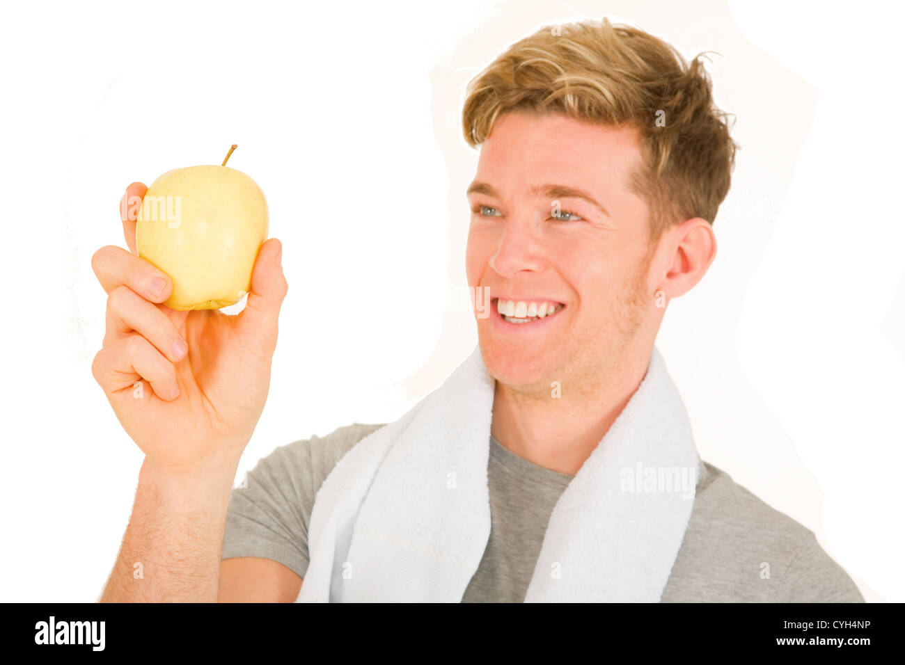 young man holding an apple Stock Photo - Alamy